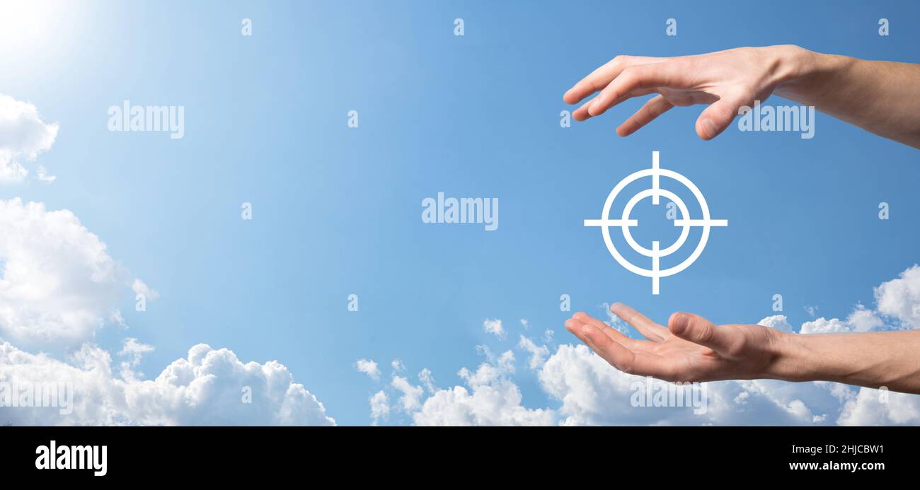 Targeting concept with businessman hand holding target icon dartboard ...