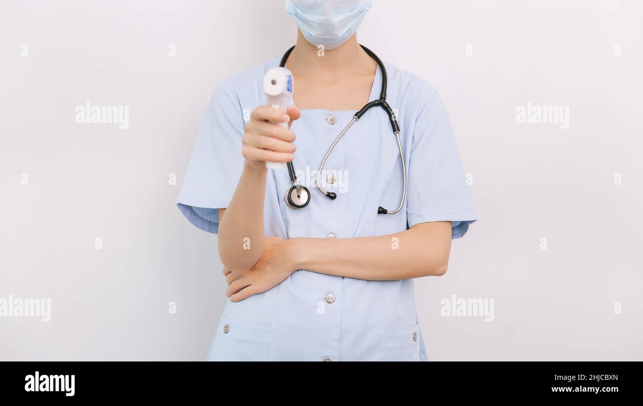 Temperature measurement gun in doctor hands. Close-up shot of doctor ...
