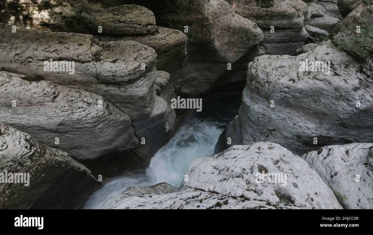 Water stream of mountainous river flowing between rocks in the narrow ...