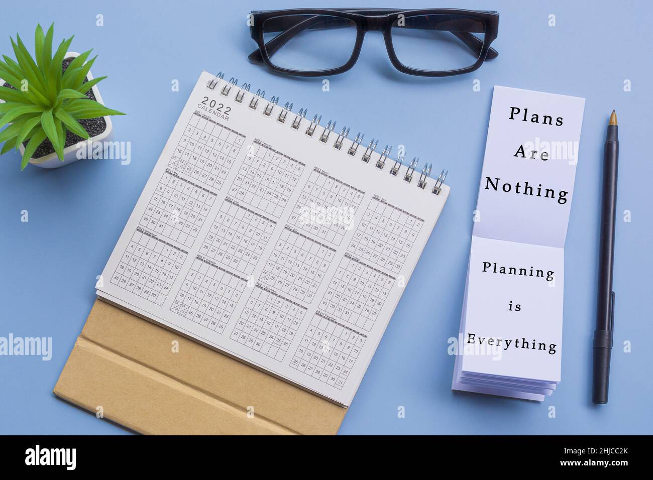 Motivational quote on notepad with 2022 calendar, glasses, pen and ...