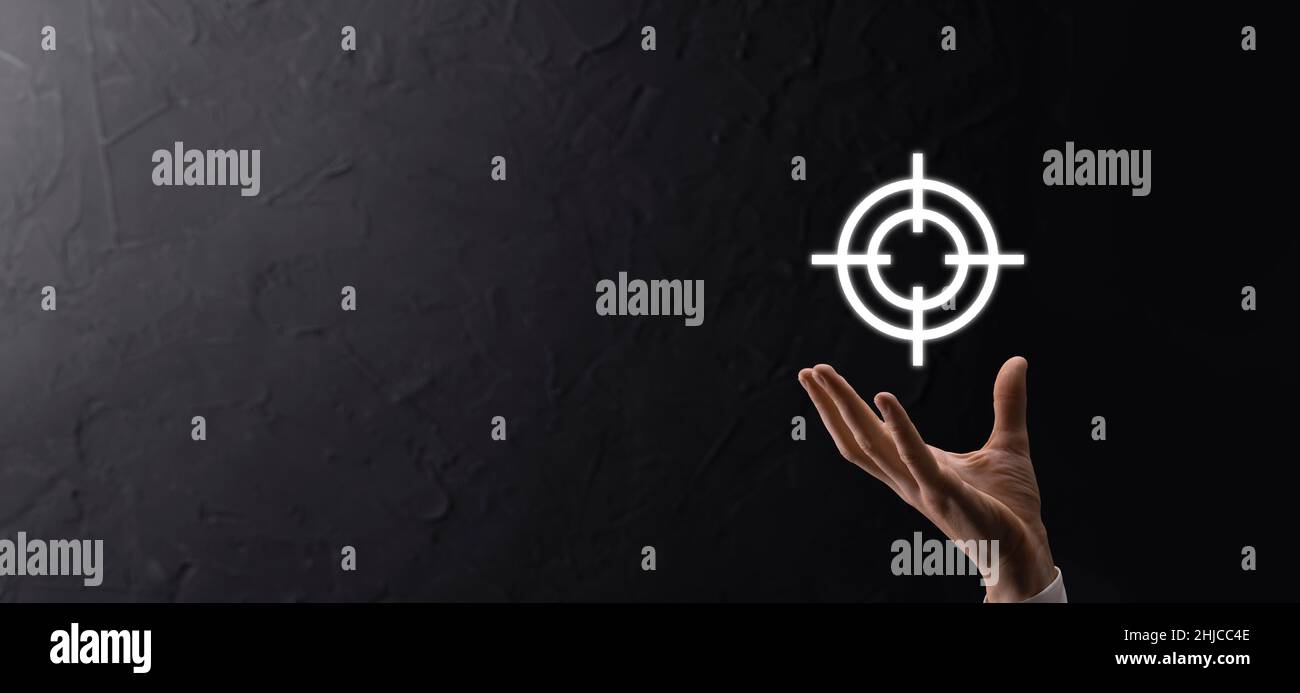 Targeting concept with businessman hand holding target icon dartboard ...