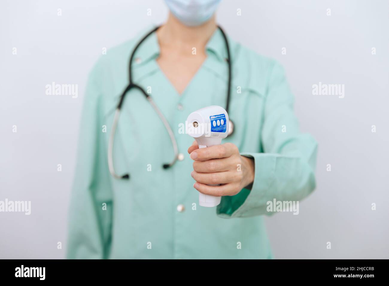 Temperature measurement gun in doctor hands. Close-up shot of doctor ...
