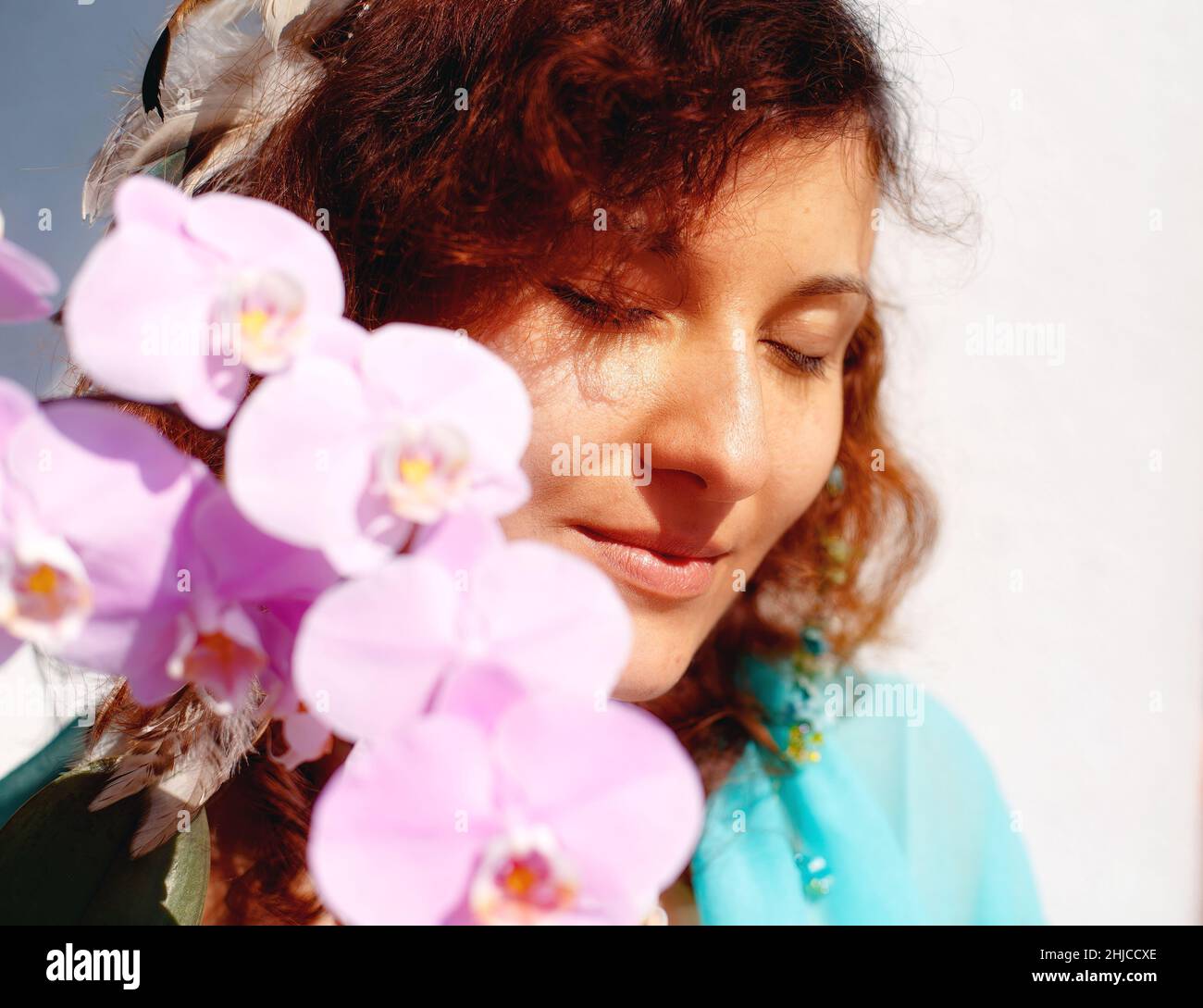 Young woman smelling a beautiful blossom. Spring Magic Stock Photo - Alamy