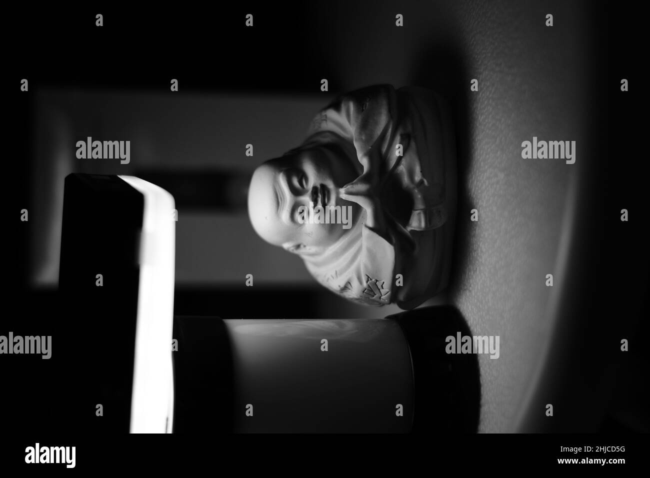 Vertical greyscale shot of a praying ceramic monk statue Stock Photo ...