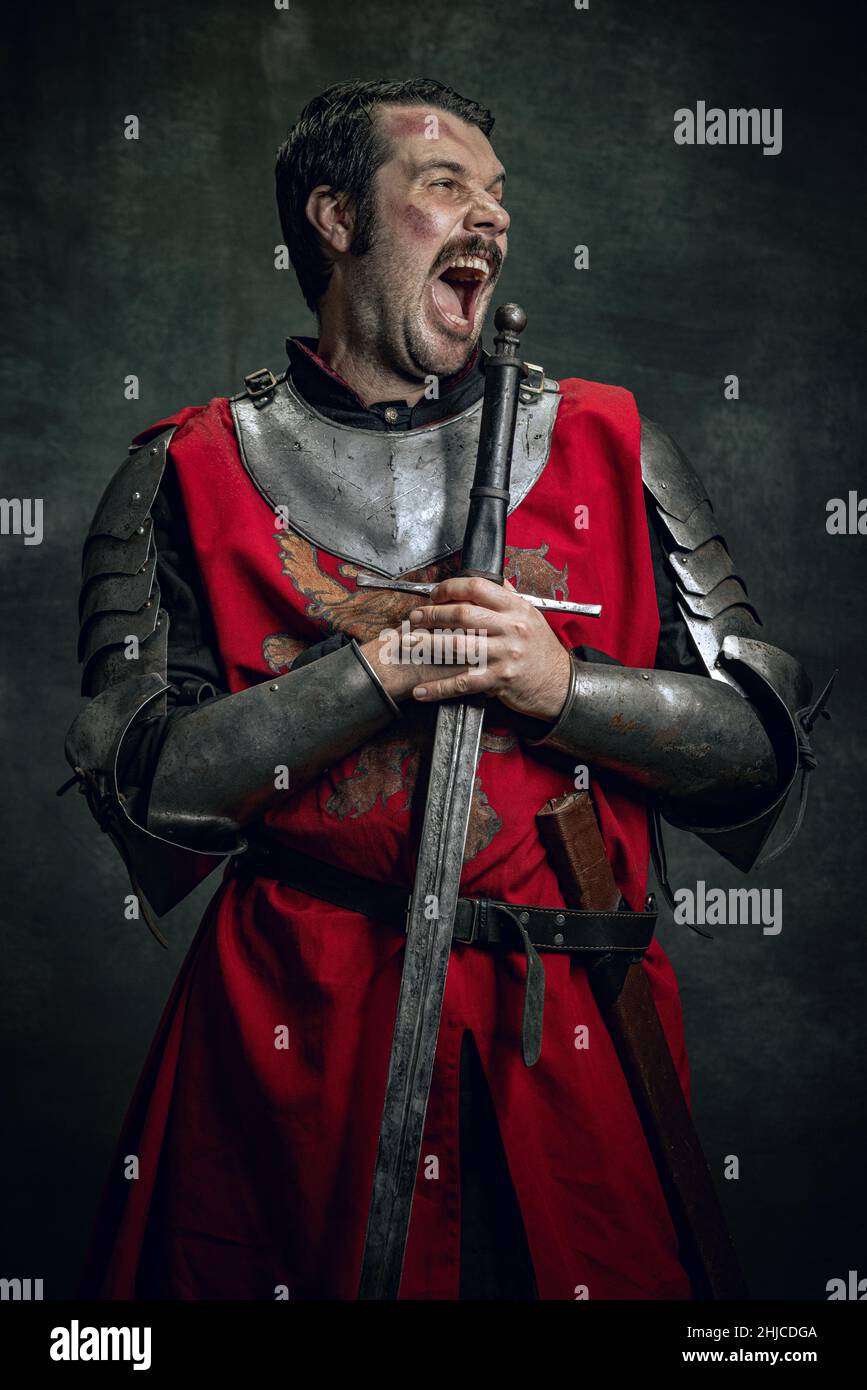 Comic portrait of funny medieval warrior or knight with dirty wounded ...