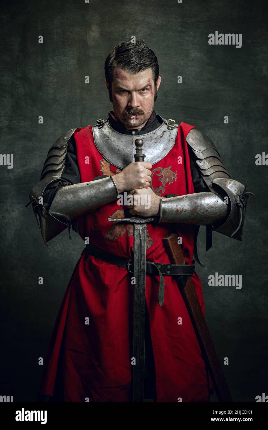 Portrait of brutal seriuos man, medieval warrior or knight with dirty ...