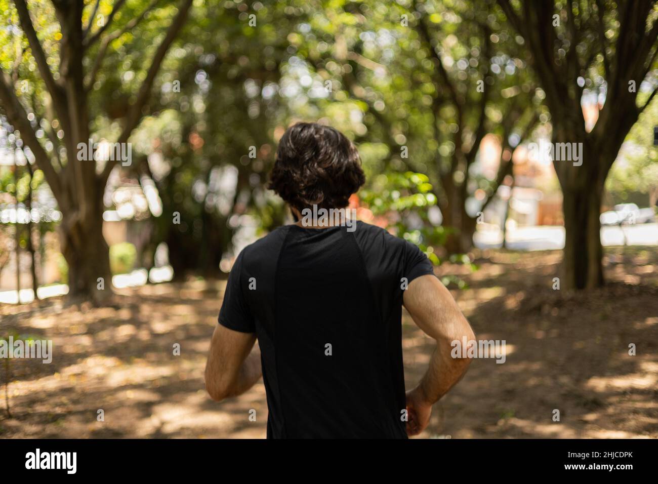 Young guy running and jogging at a park outdoors. Athlete male person ...
