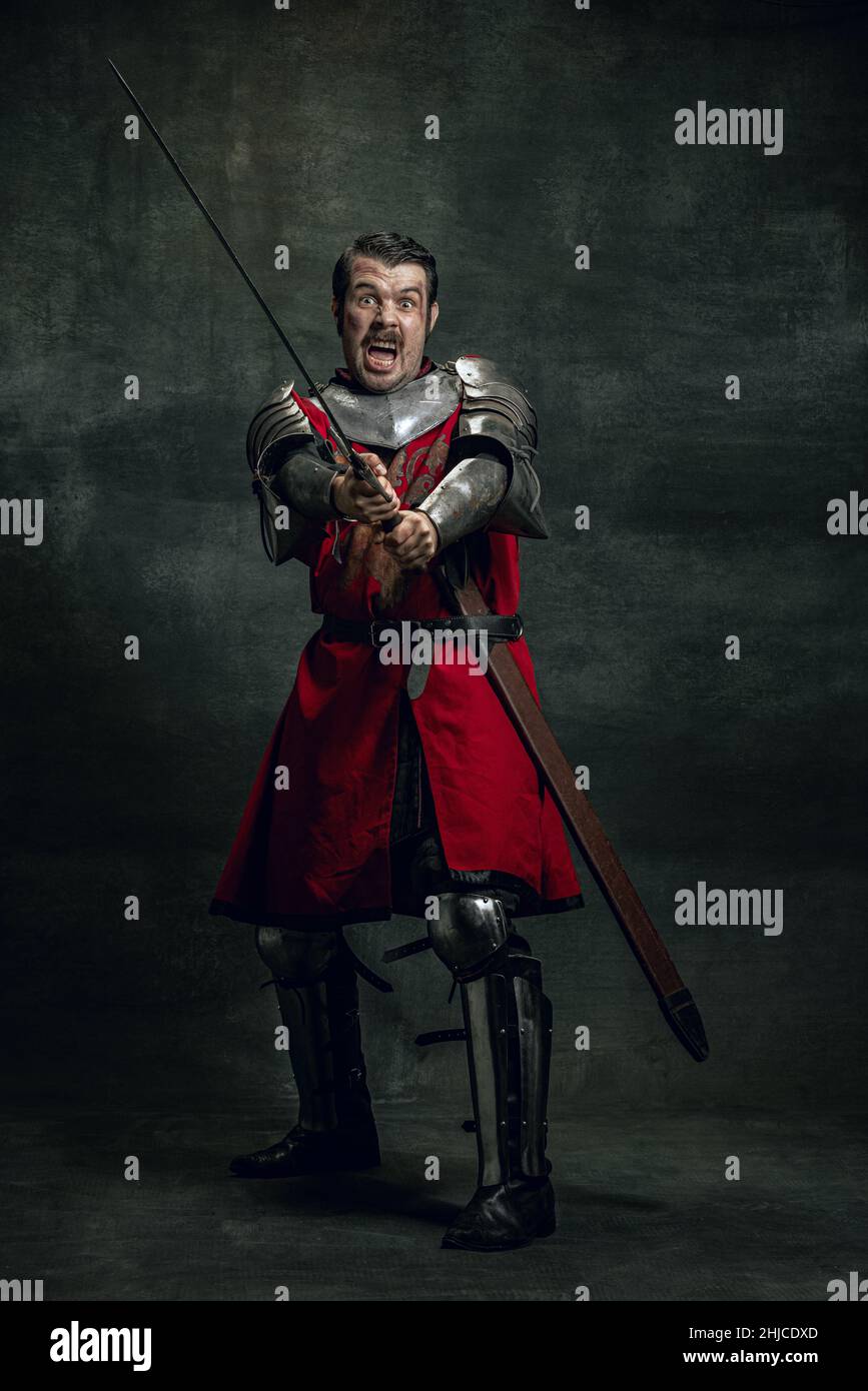 Dynamic portrait of seriuos man, medieval warrior or knight with dirty ...