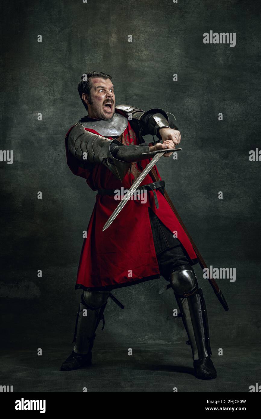 Dynamic portrait of seriuos man, medieval warrior or knight with dirty ...