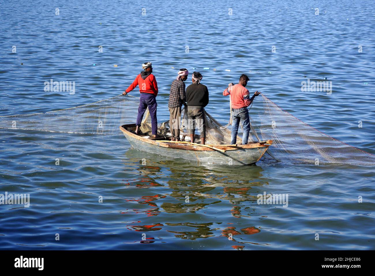 Indian fishermen catching fish inside the lake in Ajmer, Rajasthan ...
