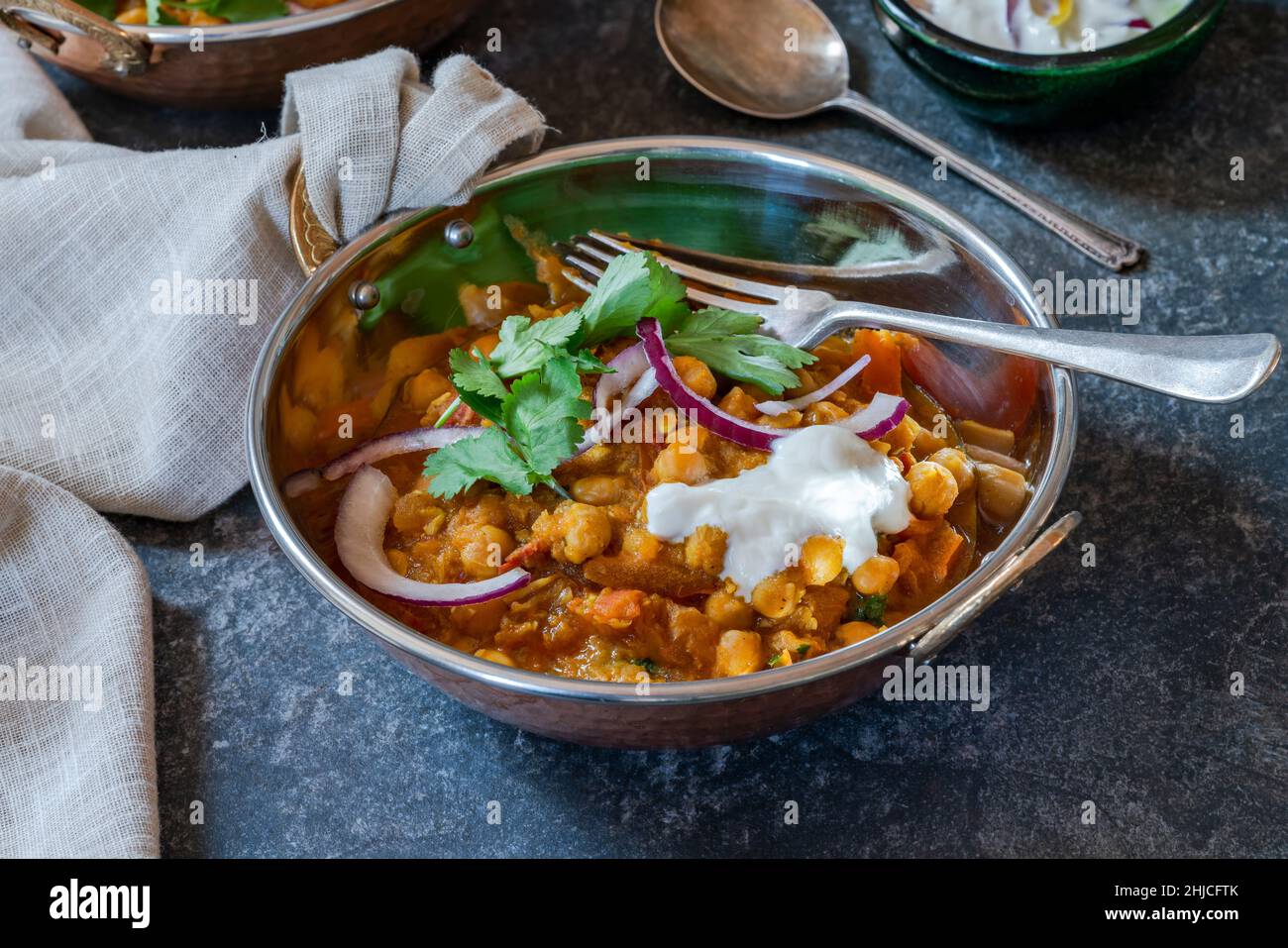 Chickpea curry with red onion raita Stock Photo - Alamy