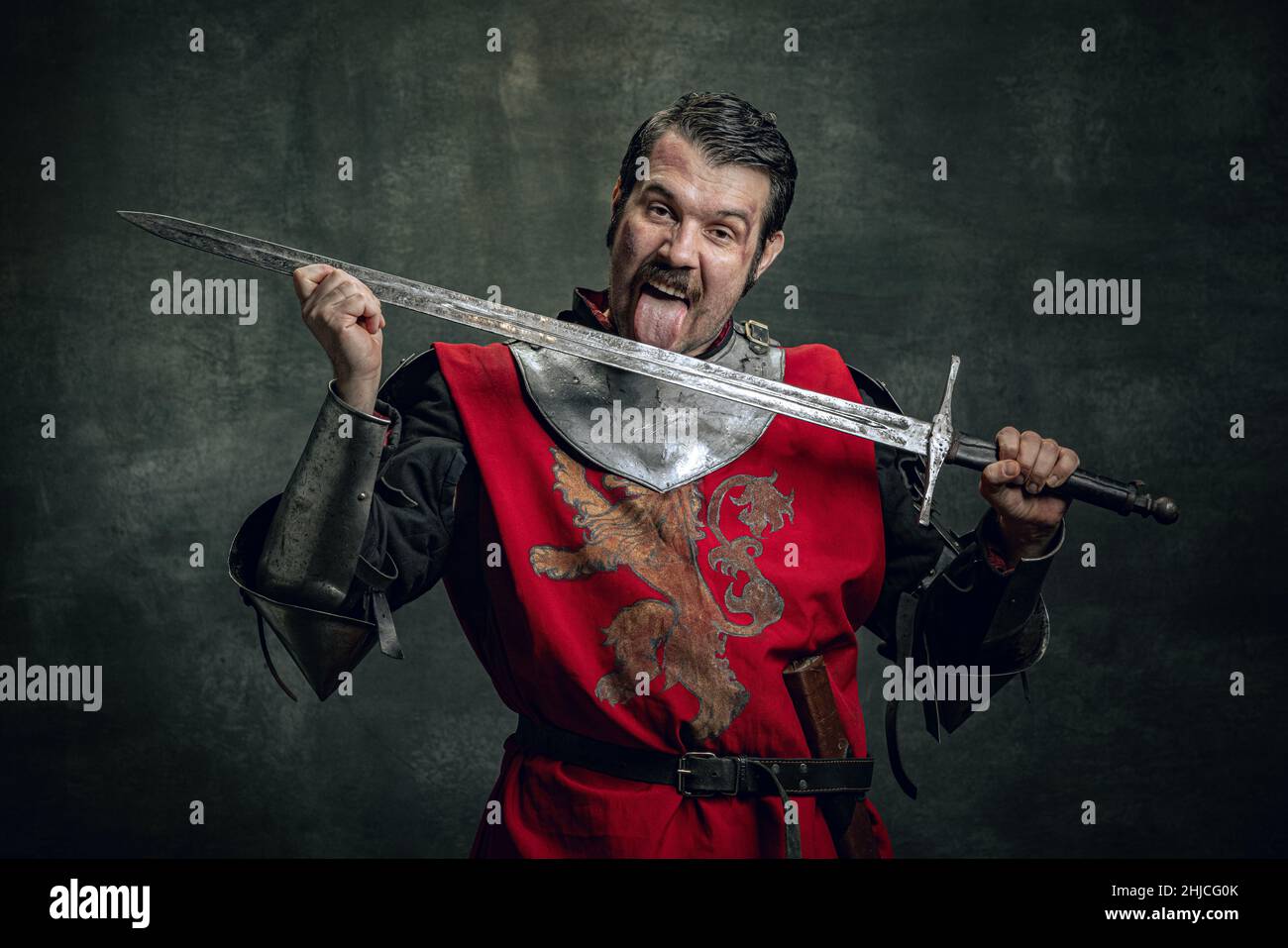 Comic portrait of funny medieval warrior or knight with dirty wounded ...