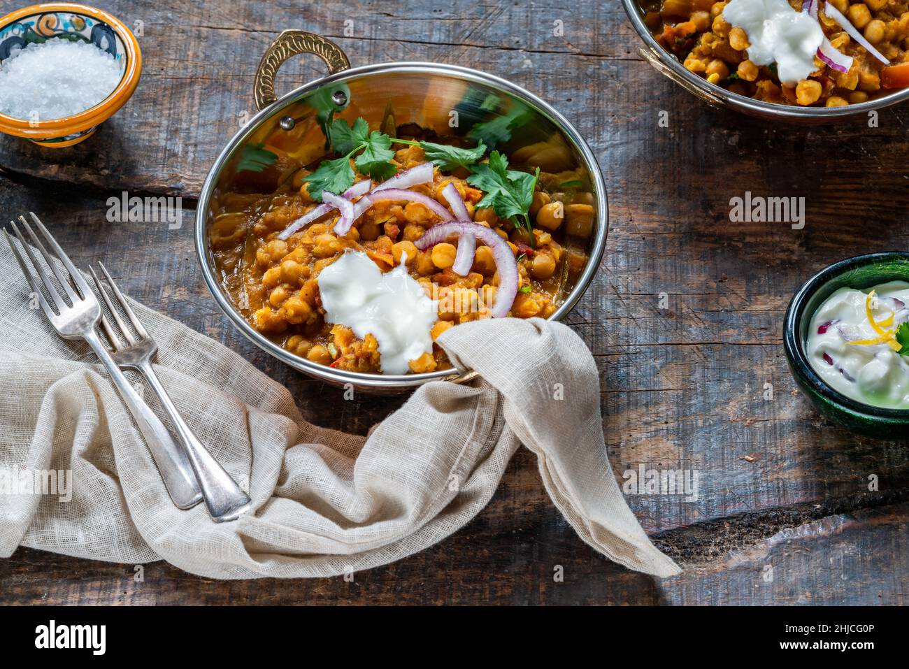 Chickpea curry with red onion raita Stock Photo - Alamy