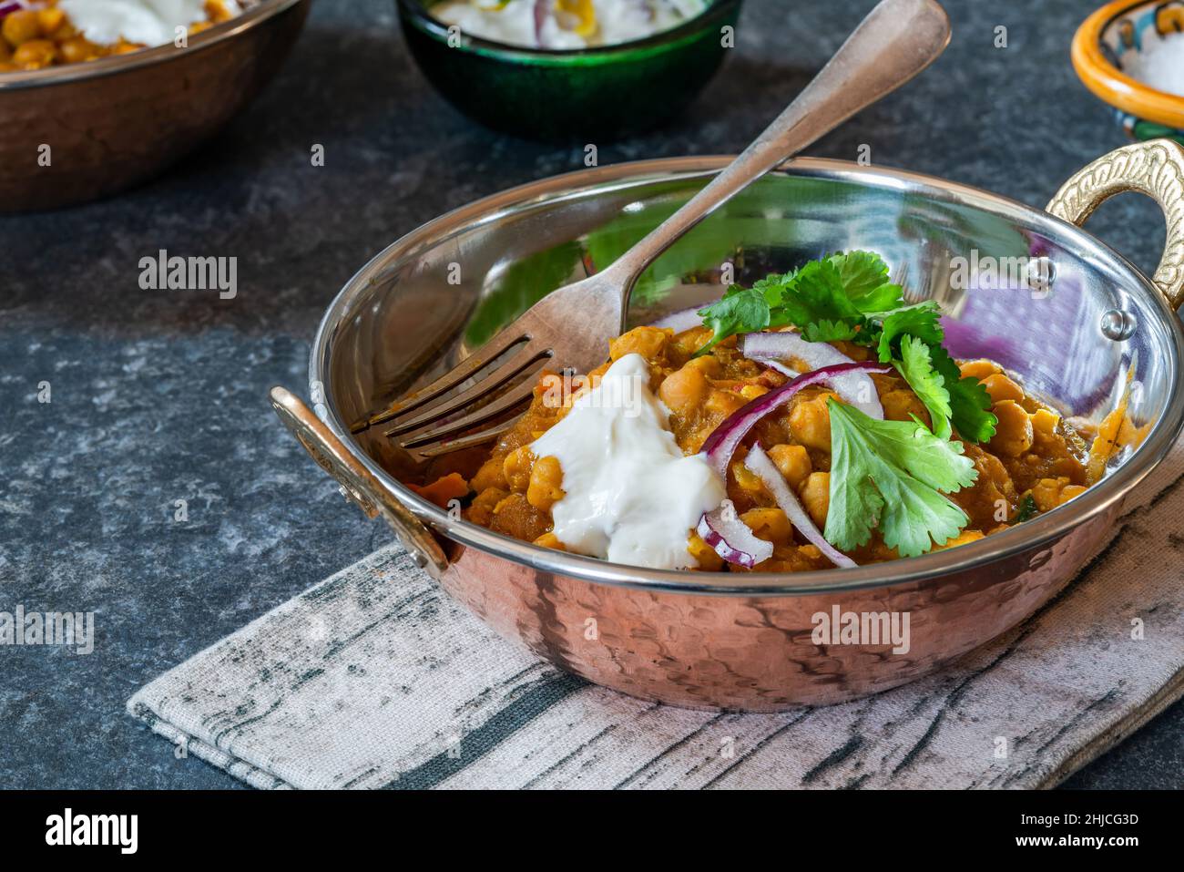 Chickpea curry with red onion raita Stock Photo - Alamy