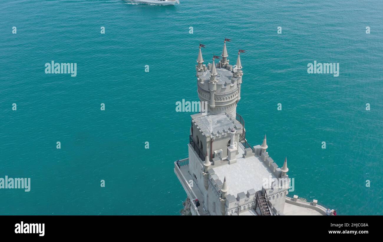 Castle on background of yacht in blue sea. Action. Top view of ...