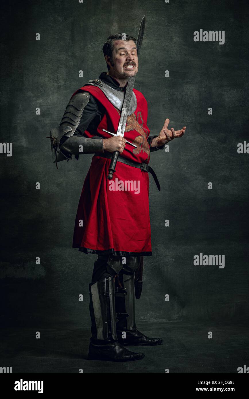 Comic portrait of funny medieval warrior or knight with dirty wounded ...