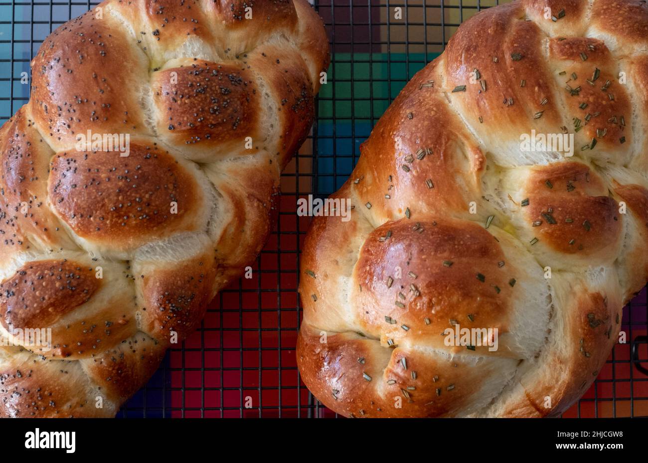 Top view of two home cooked plaited Jewish Challa bread loaves, cooling ...