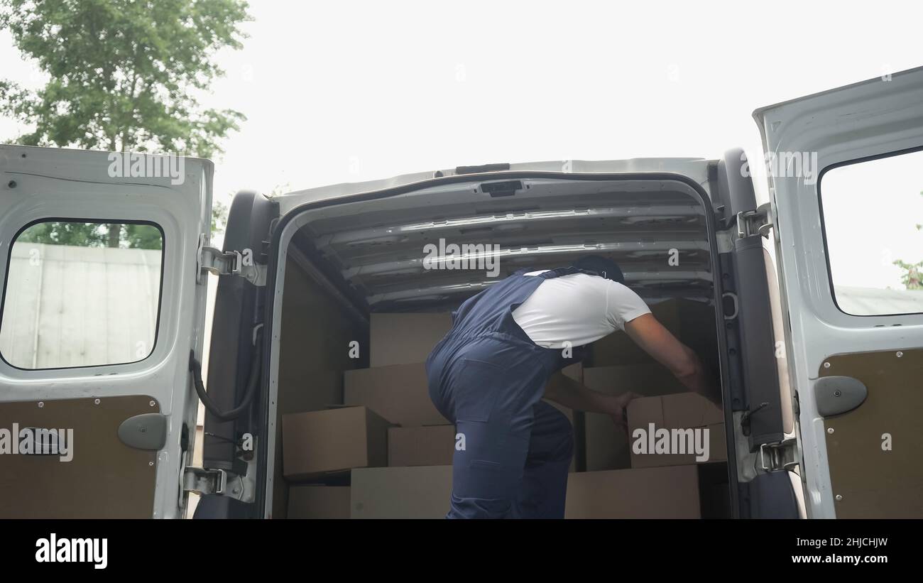 Woman delivery courier taking boxes hi-res stock photography and images ...