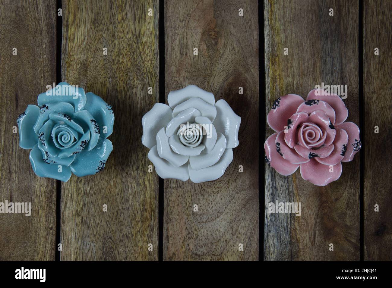 Colorful Ceramic Roses on Wooden Background Stock Photo - Alamy