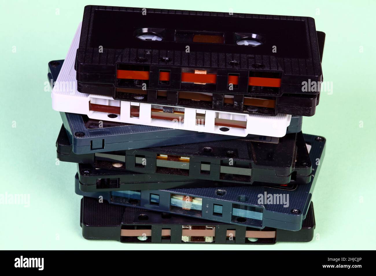 Stack of old vintage retro audio cassette tapes isolated on a green ...