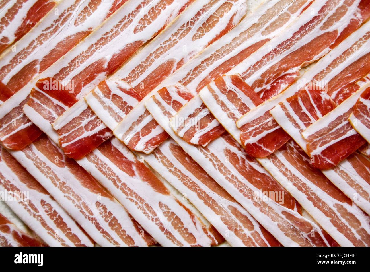 row bacon in crossing patterns, full frame as background Stock Photo ...