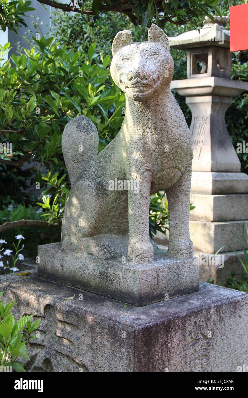 statue of a fox in a buddhist (?) temple (tenmangu) in okayama in japan ...