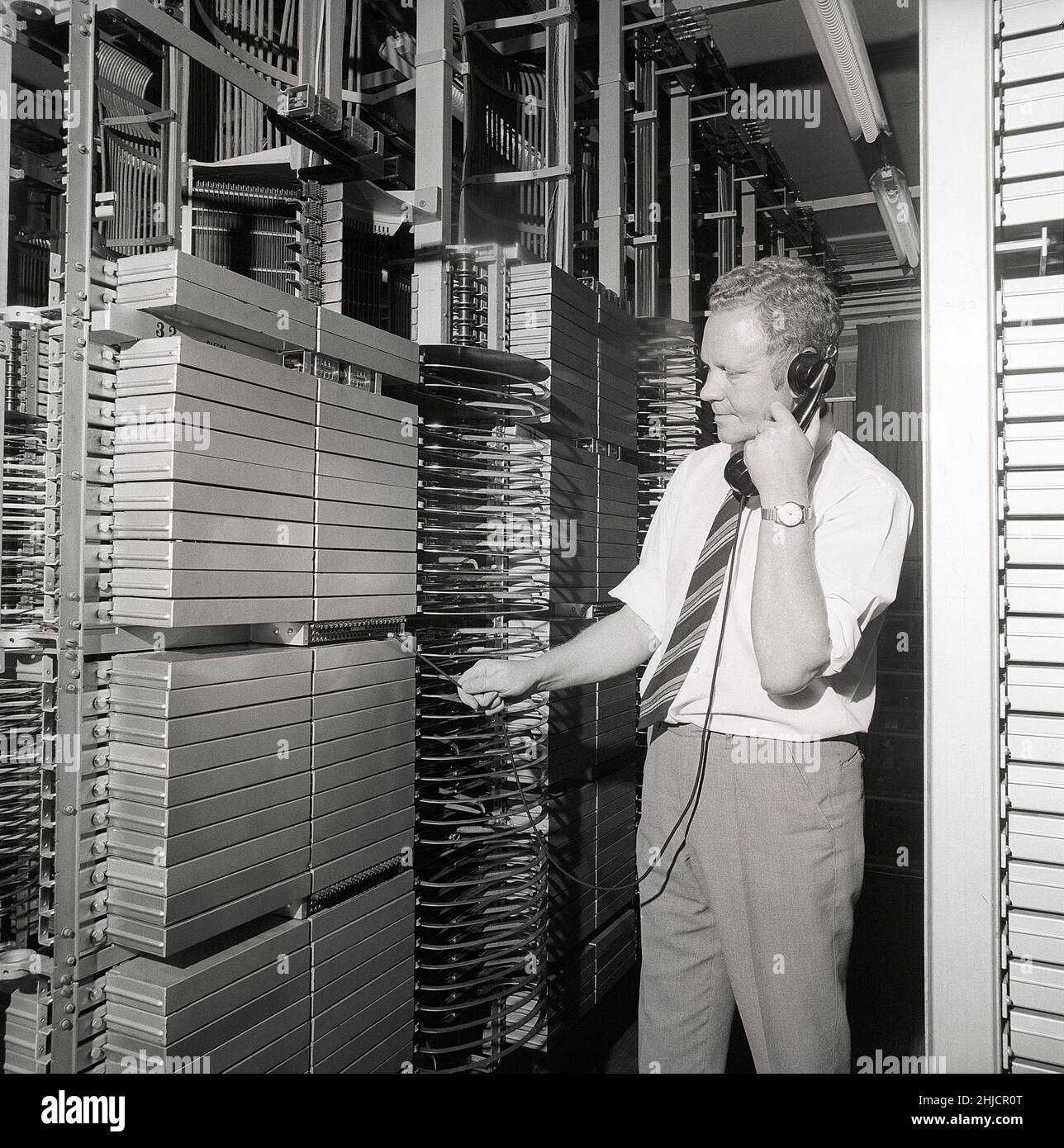 Telephony in the 1970s. A man in a room with an automatic switchboard ...
