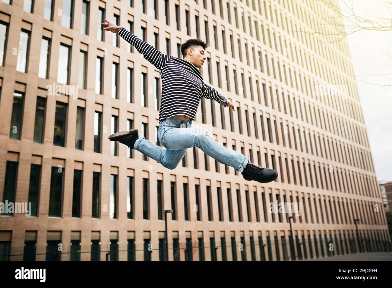 Young man jumping and dancing on the street Stock Photo - Alamy