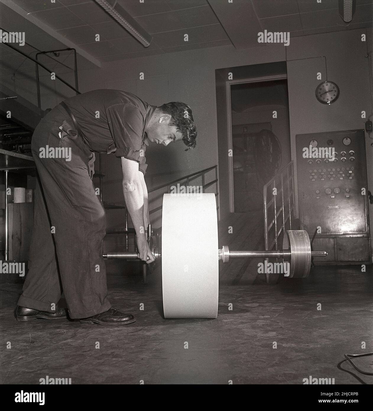 Producing postage stamps in the 1950s. A man at the swedish stamp ...