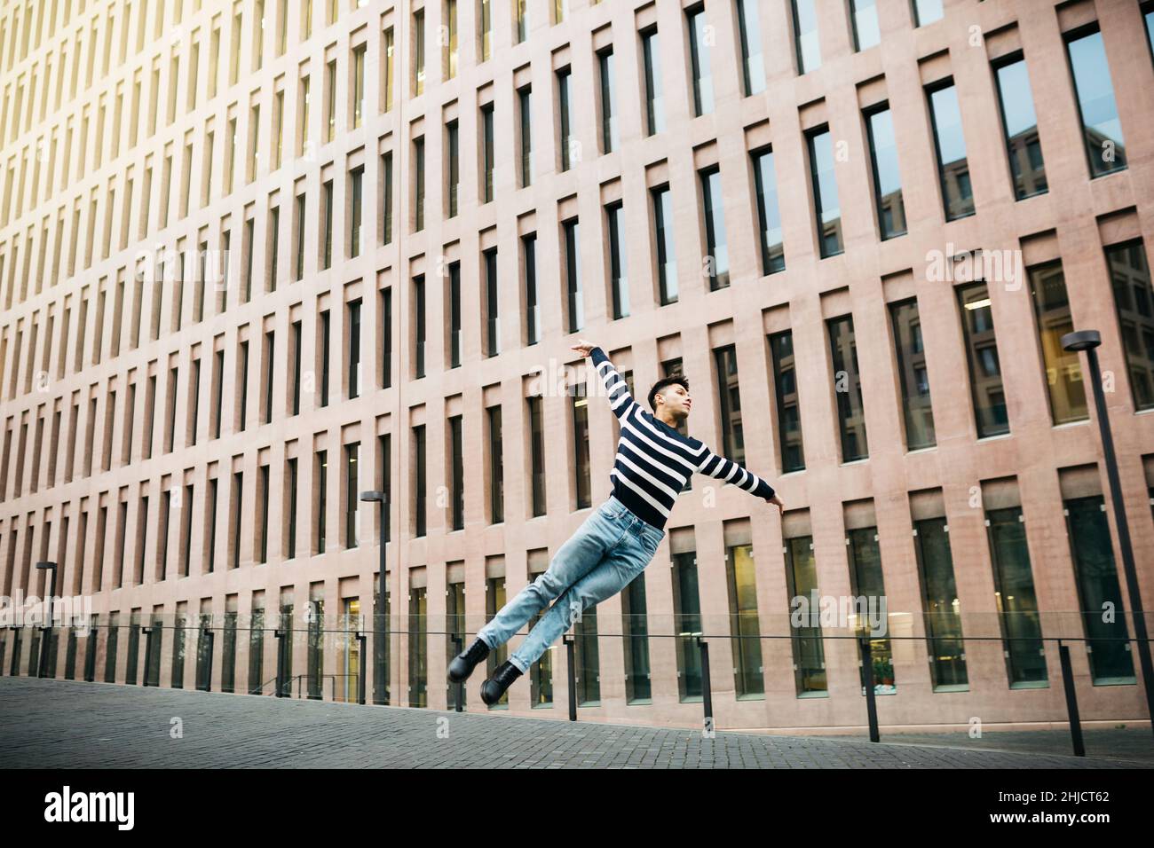 Young man jumping on the street Stock Photo - Alamy