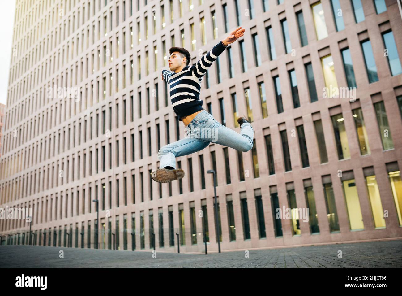 Young man jumping on the street Stock Photo - Alamy
