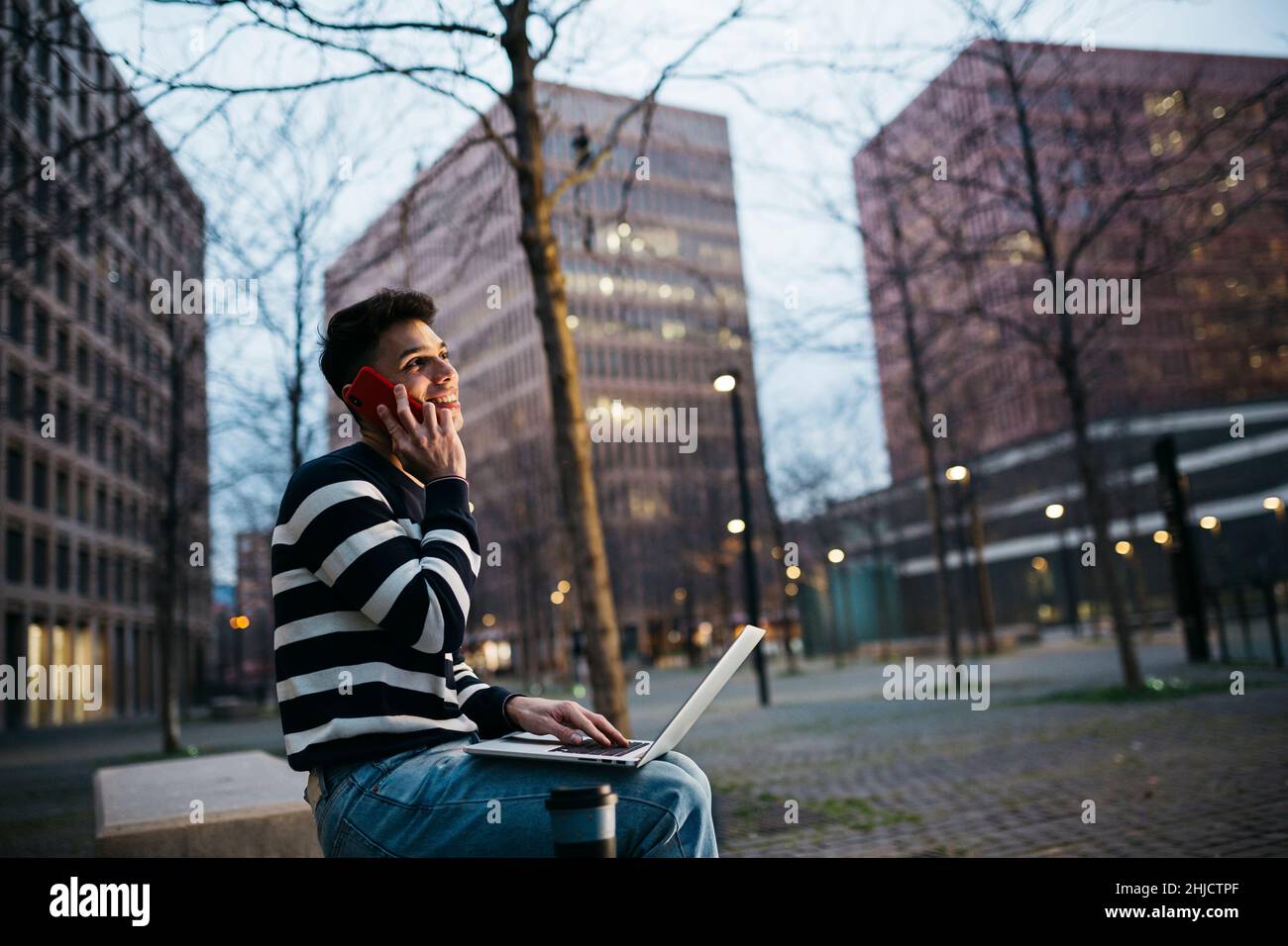 Man sitting by street hi-res stock photography and images - Alamy