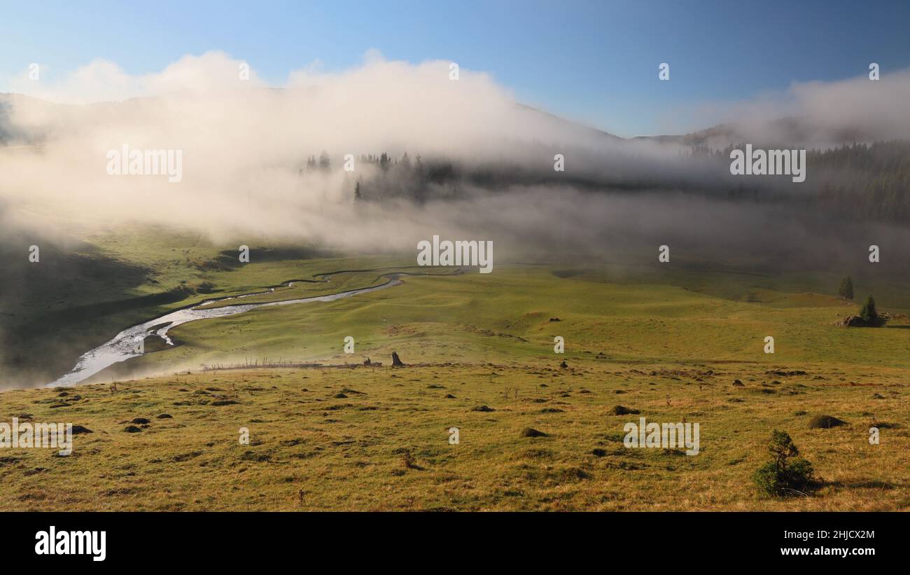 Mountain landscape with meadow and stream Stock Photo - Alamy