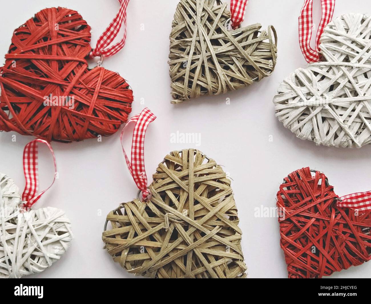 Handmade wicker hearts on a white background, top view Stock Photo - Alamy