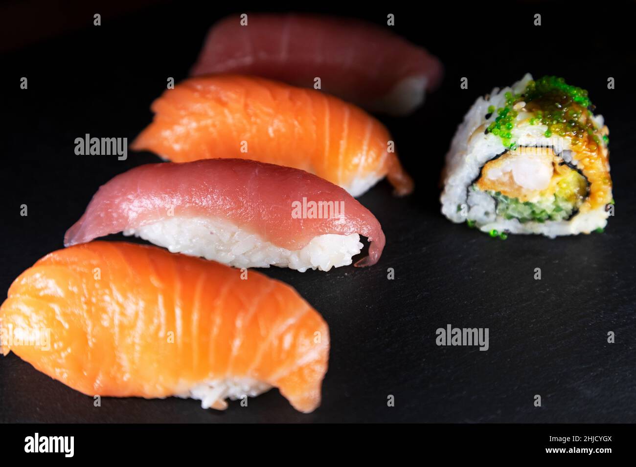 A platter of tuna and salmon nigiri served with uramaki. Types of sushi ...