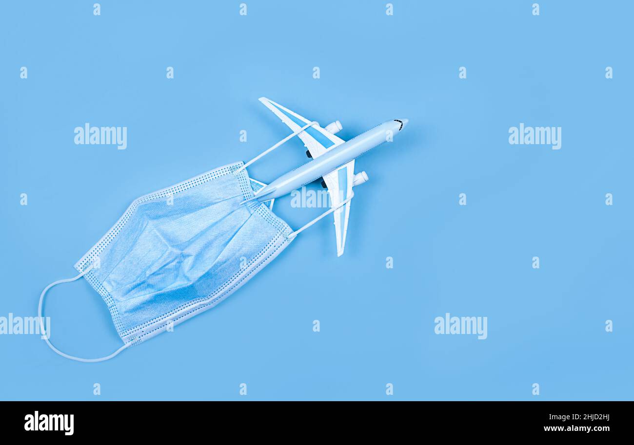 Airplane in flight with a medical mask. Concept - observance of safety ...