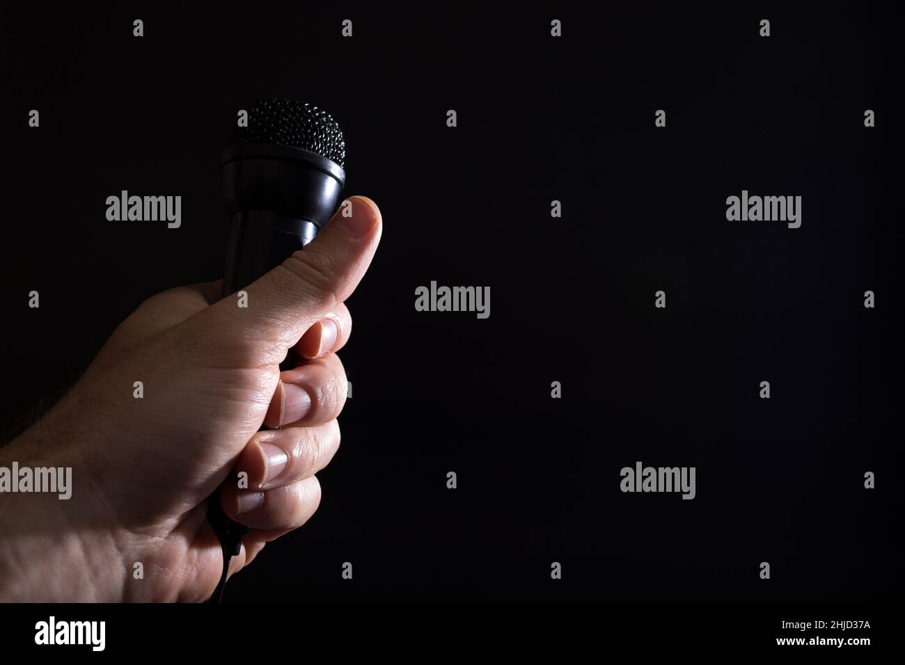 Hand holding microphone stand hi-res stock photography and images - Alamy