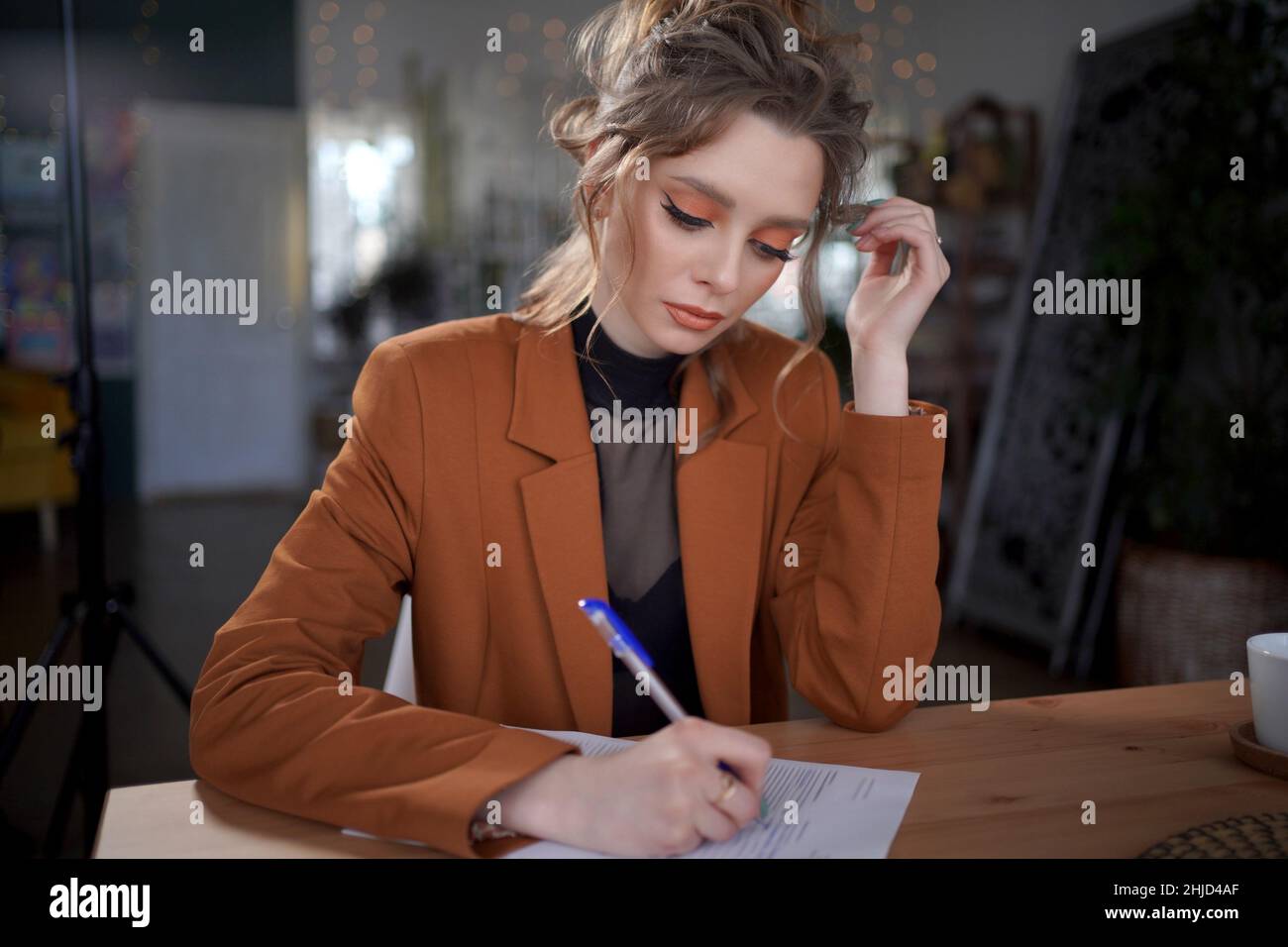 girl writes on a piece of paper Stock Photo - Alamy