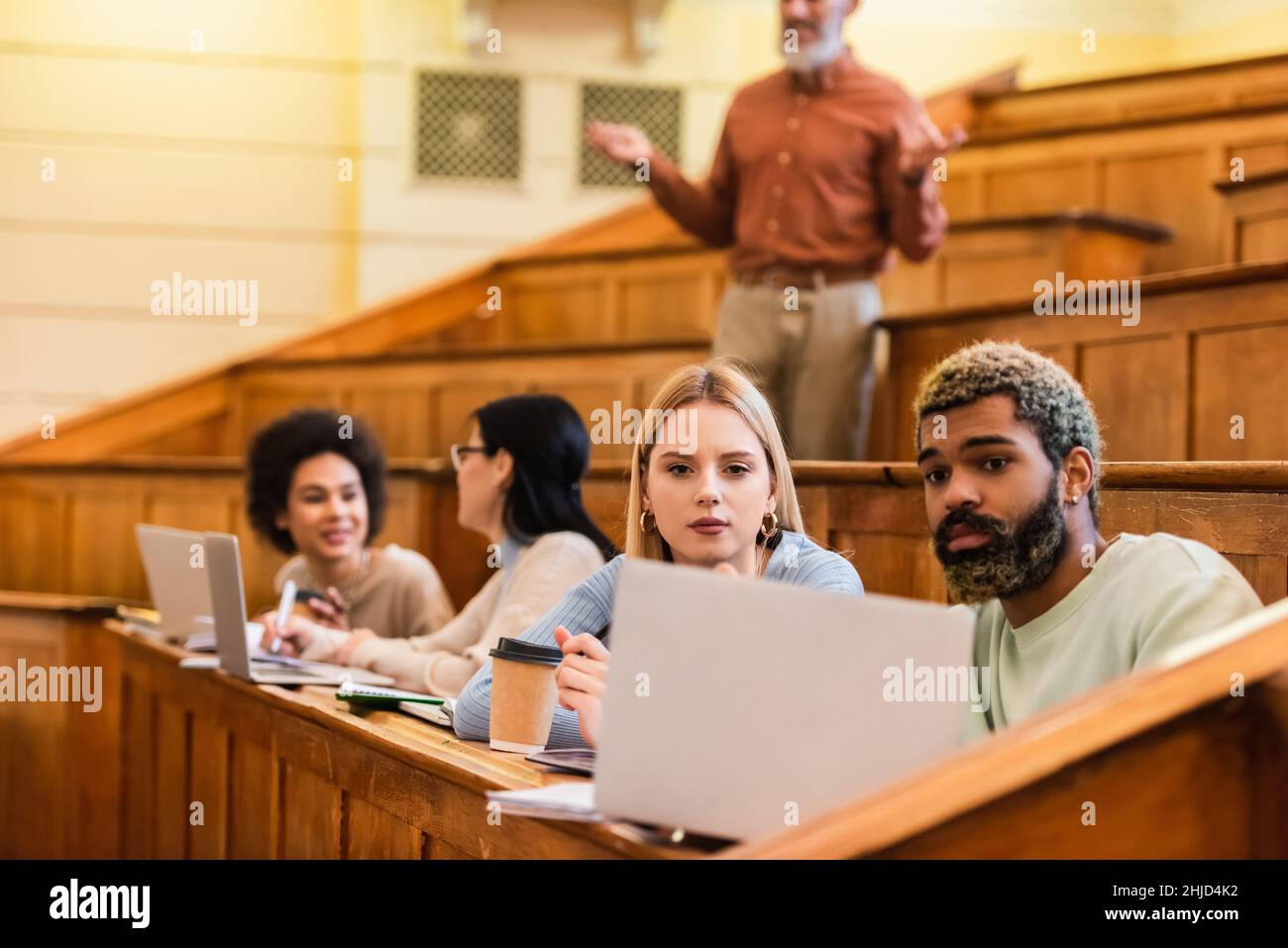 Group of students looking at laptops hi-res stock photography and ...