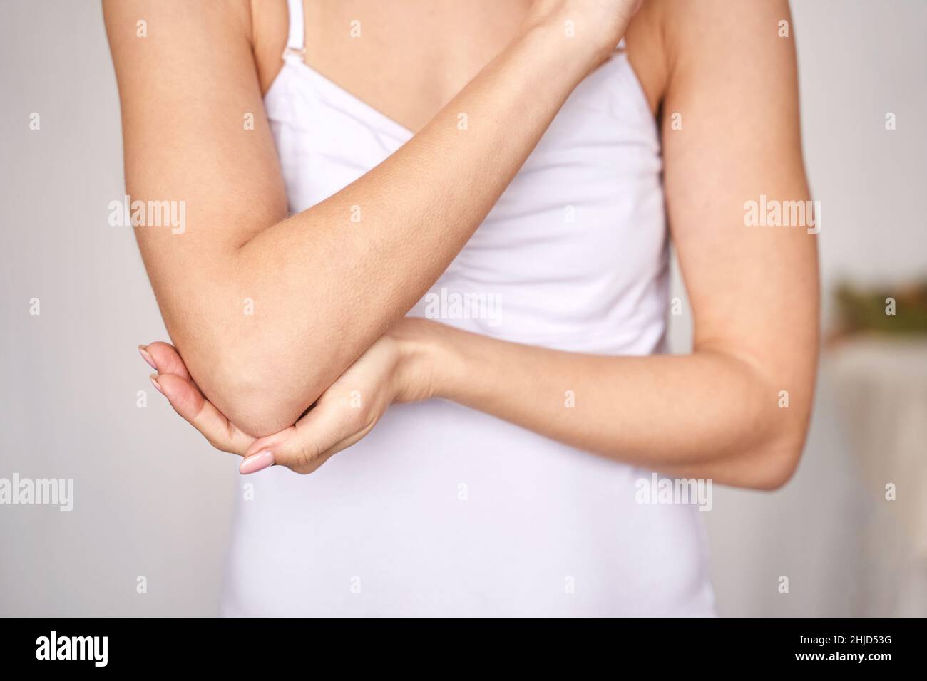 Young woman at office. Tired elbow. Female stress lifestyle. New normal ...