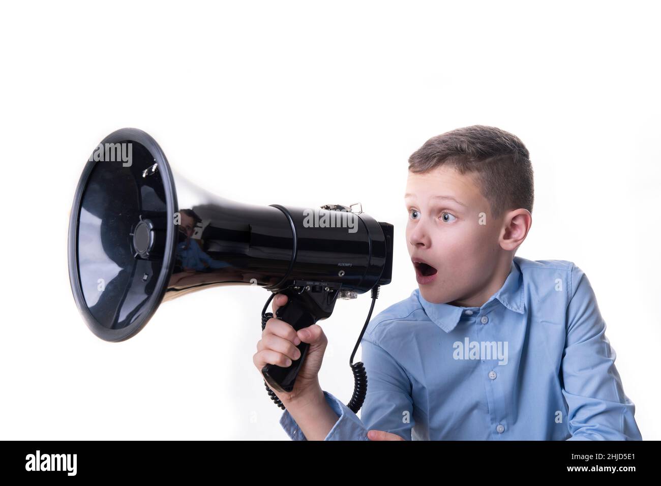 Boy shouting into a large black megaphone from the front with a white ...