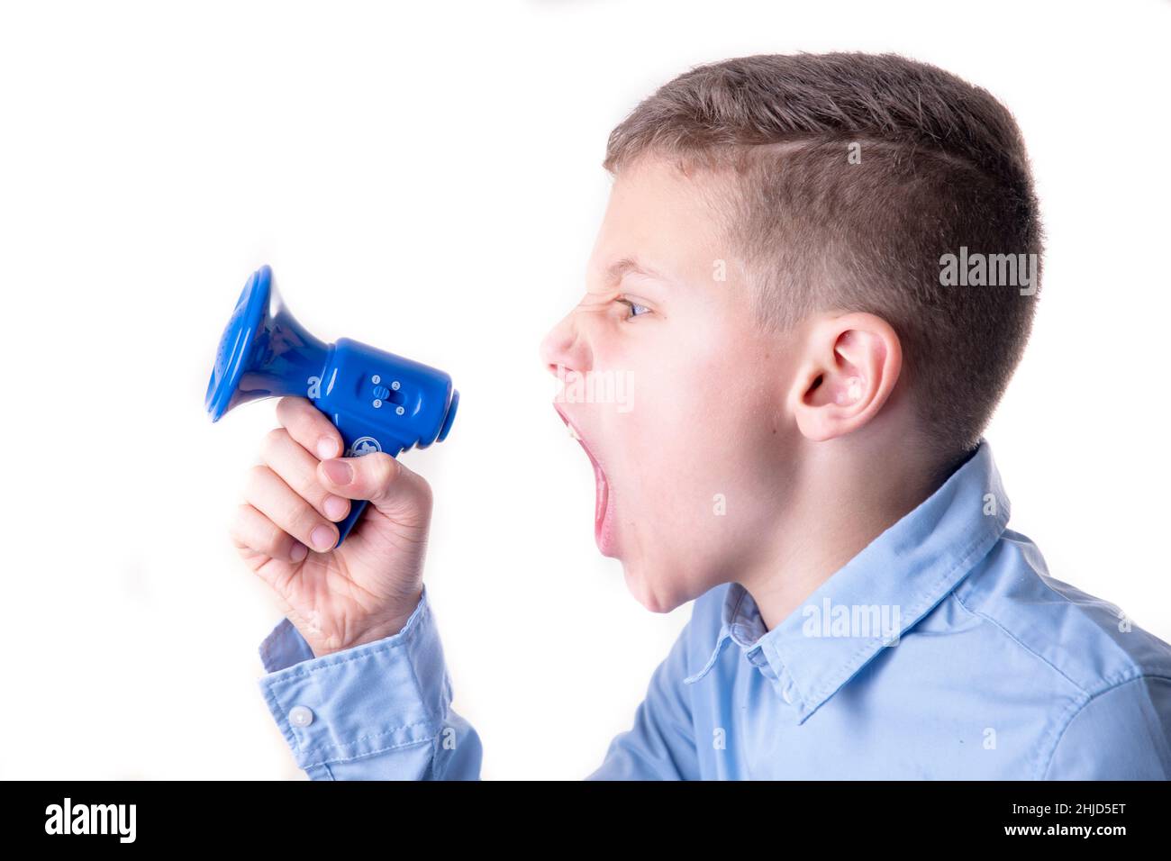 Boy shouting into a very small blue megaphone from the front with a ...