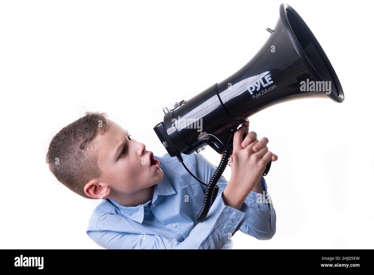 Boy shouting into a large black megaphone from the front with a white ...