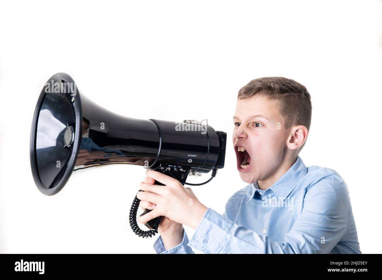 Boy shouting into a large black megaphone from the front with a white ...