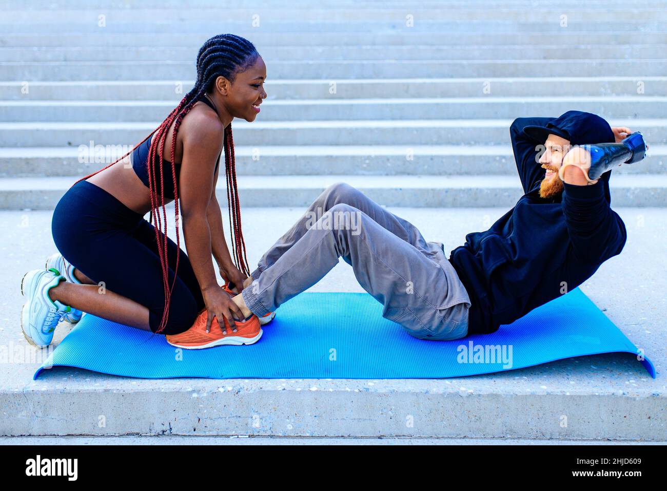 mixed race friends fitness training together outdoors summer morning ...