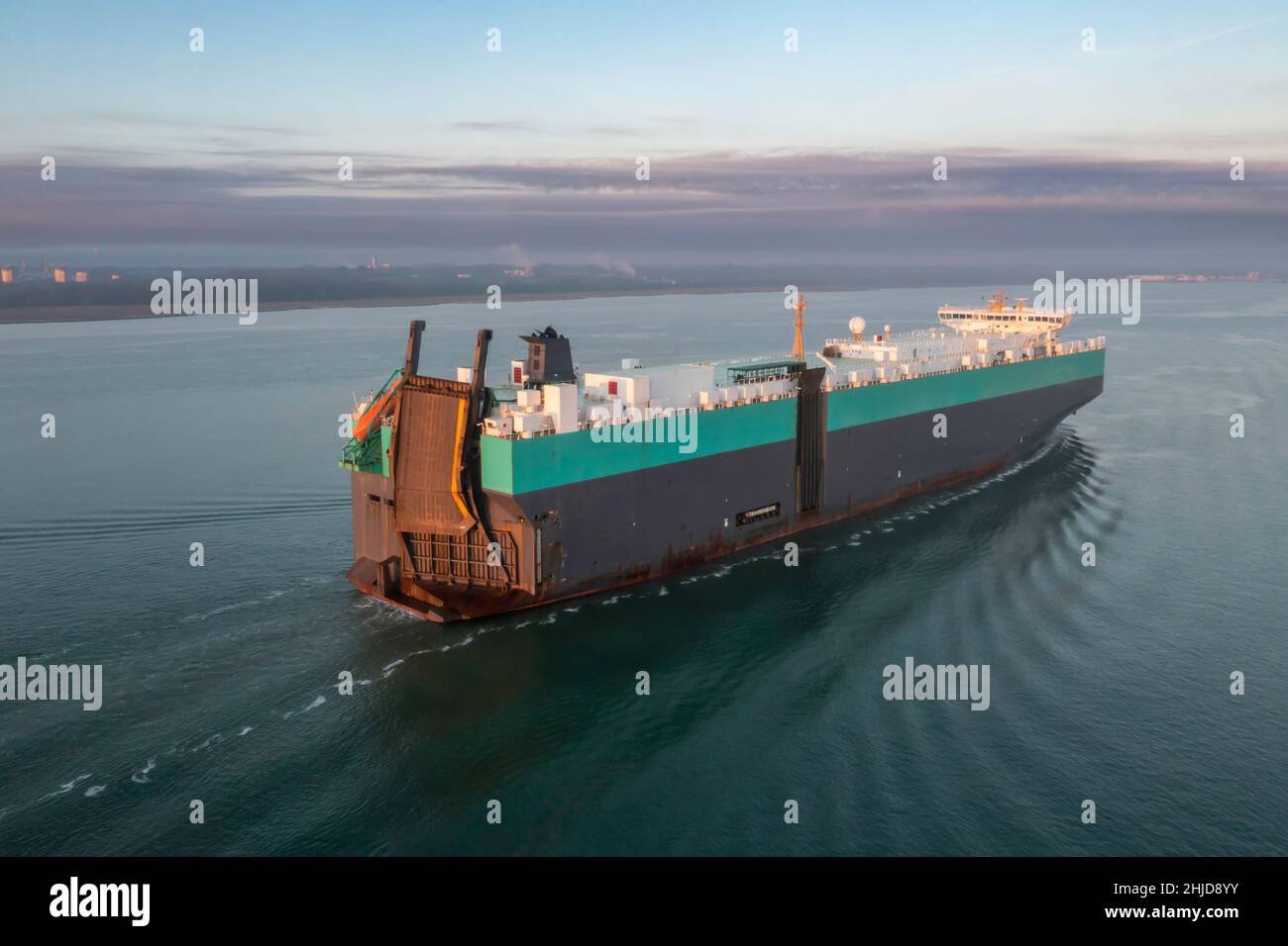 A roro vehicle carrier early morning with fog, merchant ship arriving ...