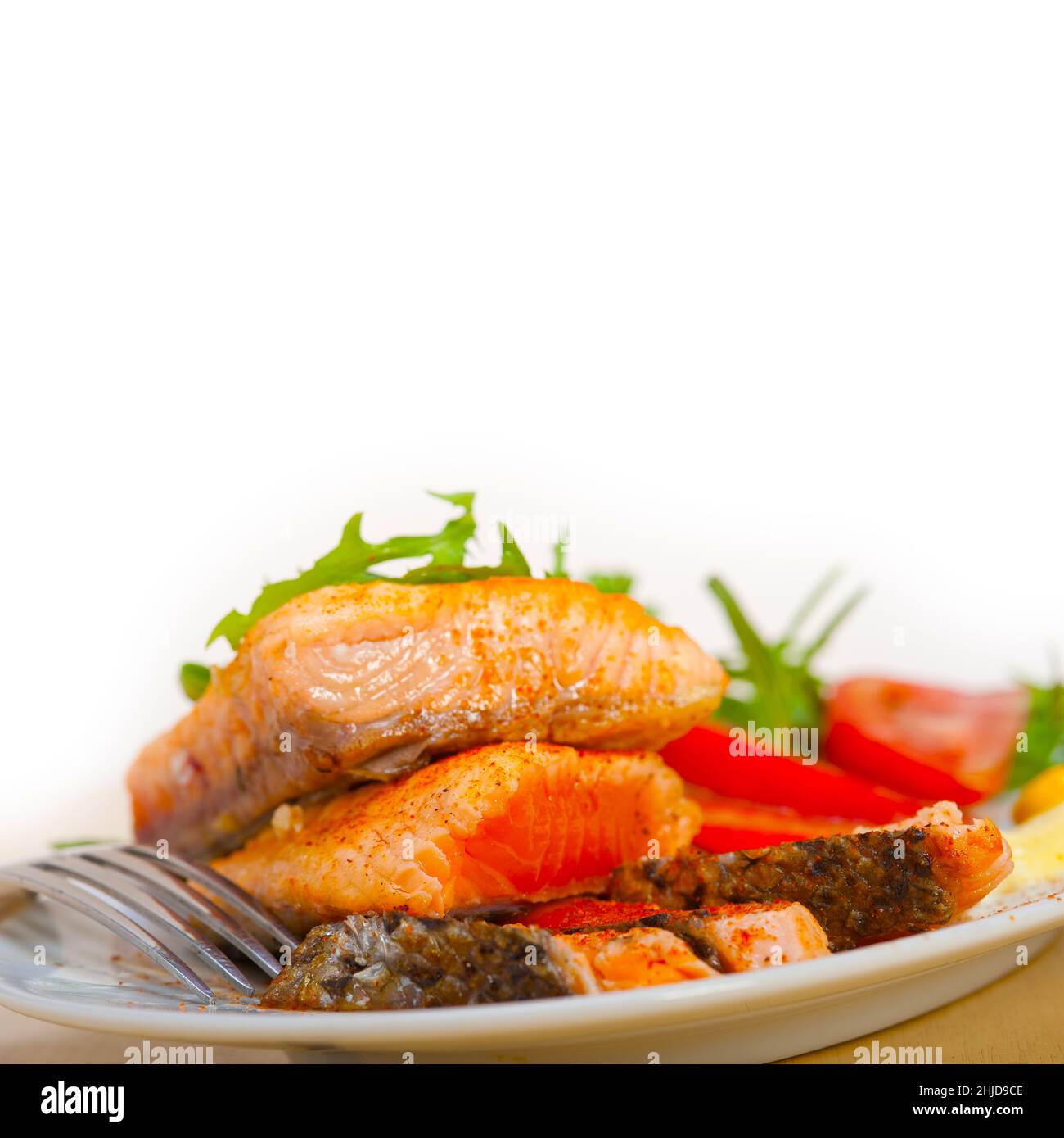 grilled fresh samon filet with vegetables salad tomato arugula ...