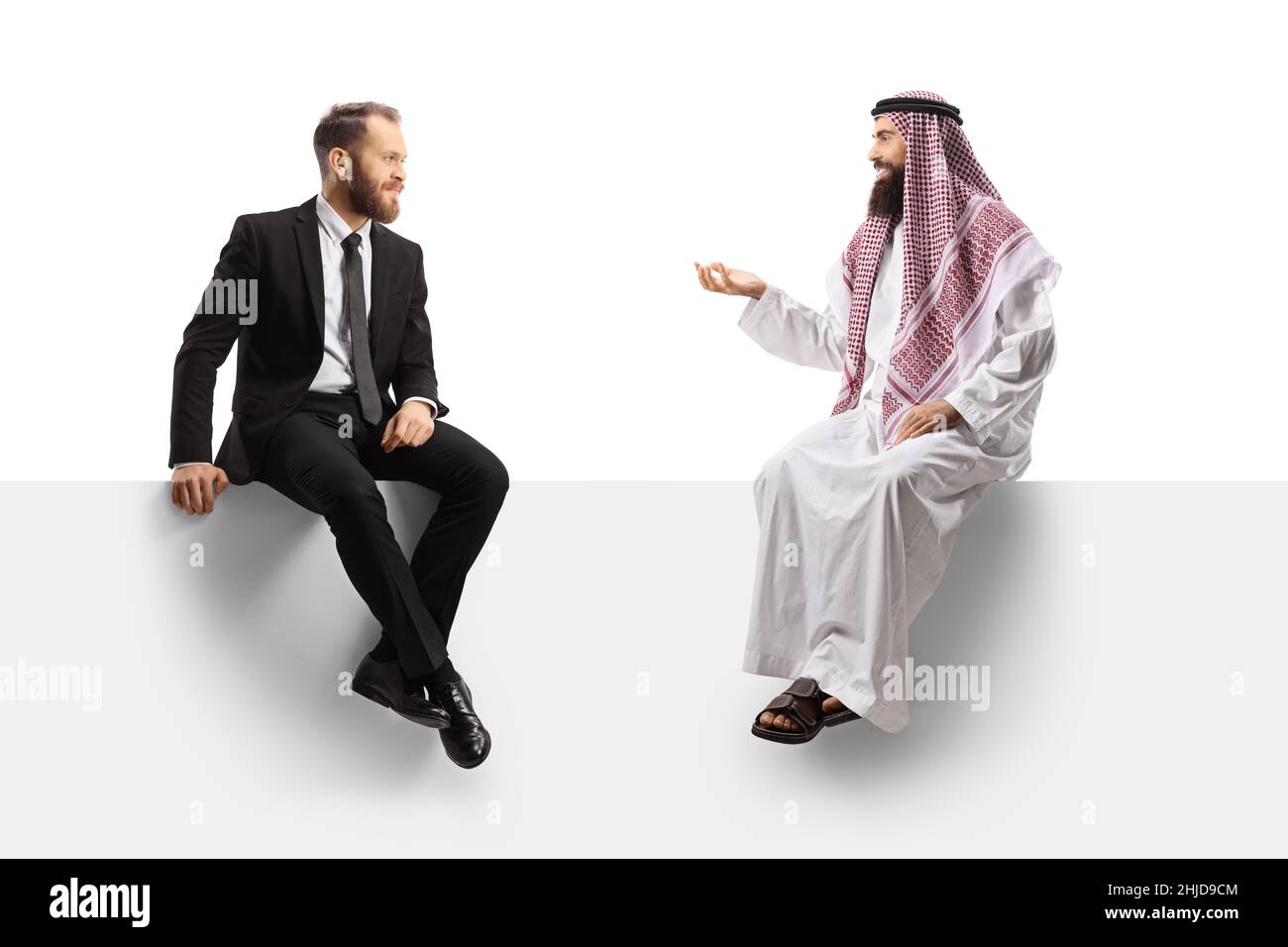 Young businessman and a saudi arab man in ethnic clothes having a ...