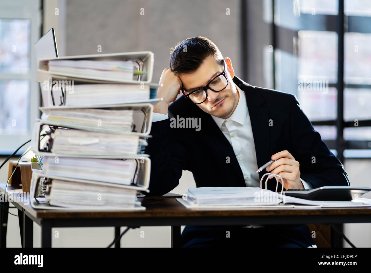 Bored Workaholic Businessman At Office Desk With Stress Stock Photo - Alamy