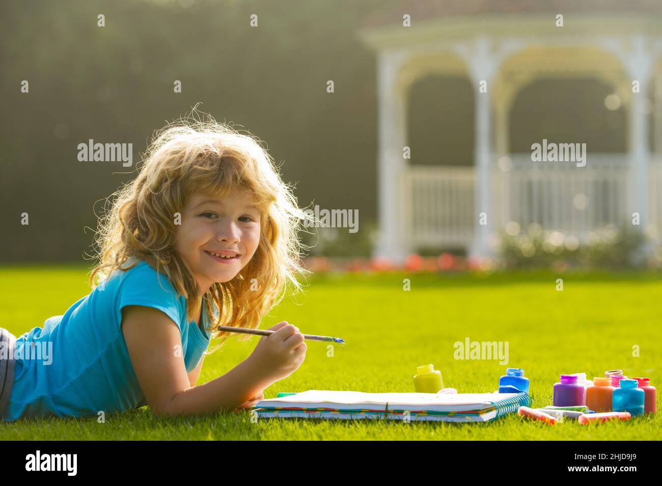 Children draw paint pictures outside, childrens creativity. Child boy ...